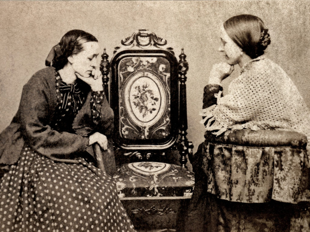 Civil War era portraits of people posed with empty chairs.